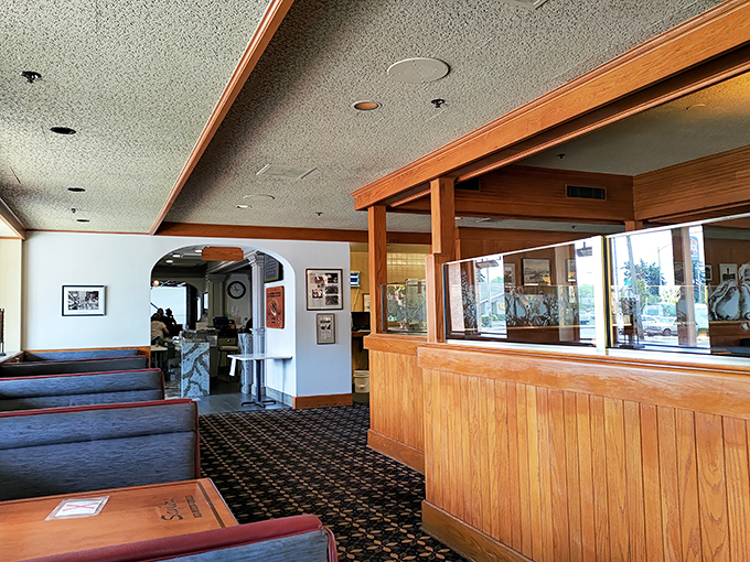 The reception area welcomes you with wood-paneled warmth. That carpeting has guided countless hungry patrons to their steak destiny.