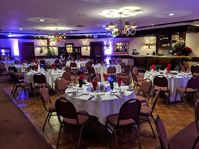 The banquet room stands ready for celebration, with tables dressed in white linens. Where memories are made between bites of exceptional food.