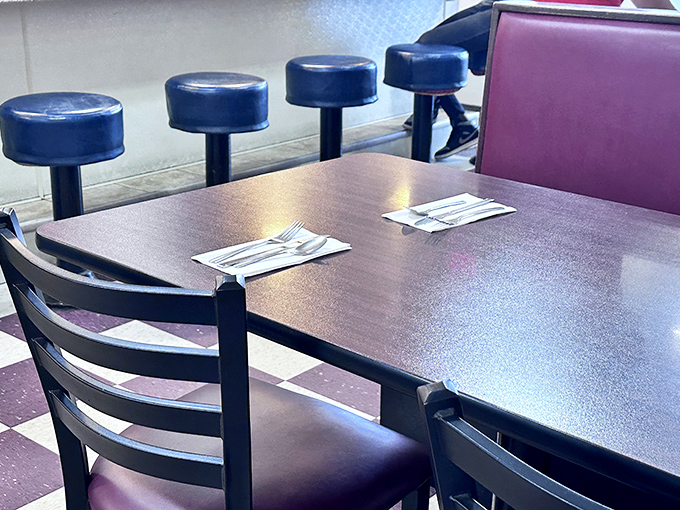 Blue counter stools waiting for the next hungry patron. In diner geometry, the counter is where solo diners become part of the community.