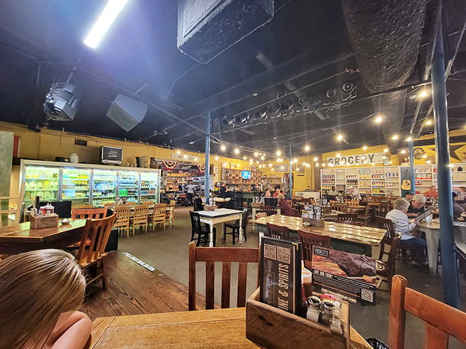 The dining room buzzes with conversation and anticipation, where refrigerated cases and "GROCERY" signs remind you of Puckett's humble beginnings and authentic roots.