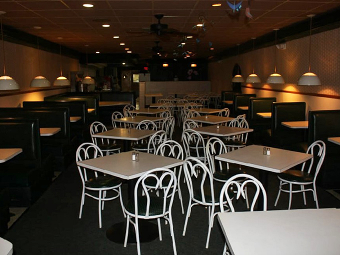 Clean lines, white chairs, and warm lighting create a dining room that says "stay awhile" without having to say a word.
