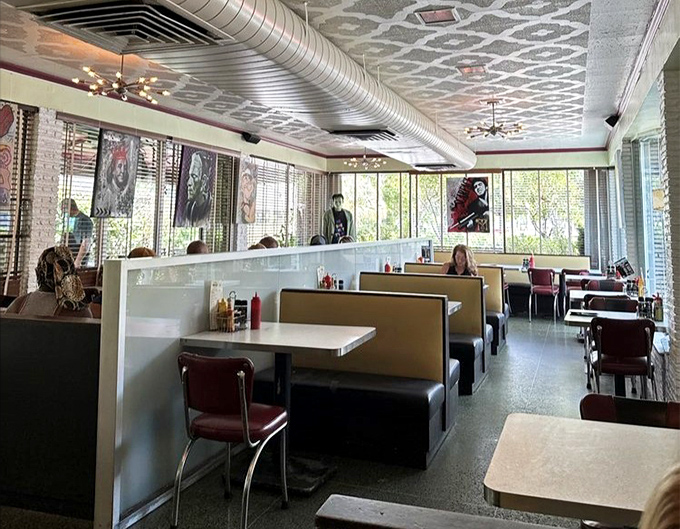 Classic diner booths bathed in natural light, with local art adding splashes of personality. The perfect backdrop for both first dates and family reunions.