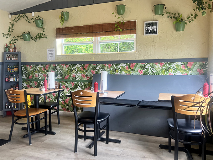 Tropical wallpaper and hanging plants create a distinctly Florida vibe. Like breakfast in your stylish friend's sunroom.
