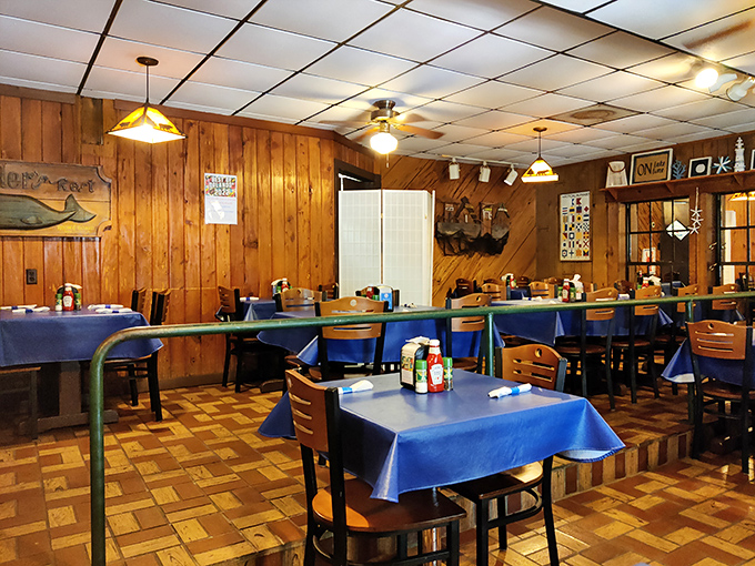 The dining room's wood-paneled warmth and blue tablecloths create the perfect backdrop for seafood stories and satisfied sighs between bites.