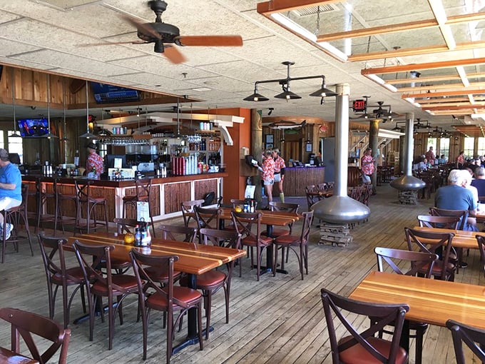 Wooden floors weathered by countless sandy feet tell stories of beach days and seafood feasts. This is Florida dining at its most authentic.