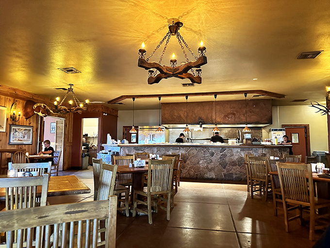 Western charm meets dining comfort. Rustic chandeliers cast a warm glow over wooden tables where countless memorable meals have unfolded.