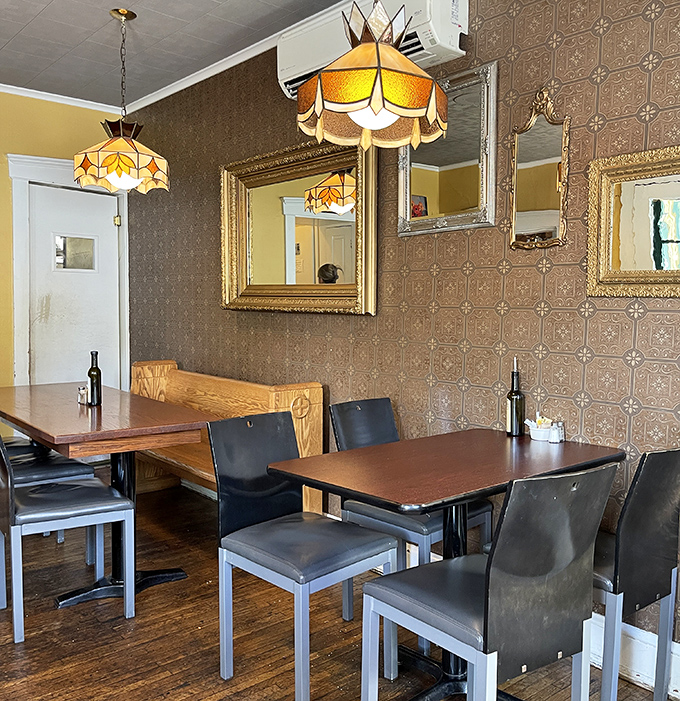 Vintage-inspired lighting casts a golden glow over walls adorned with mirrors that have witnessed countless "mmms" of breakfast satisfaction.