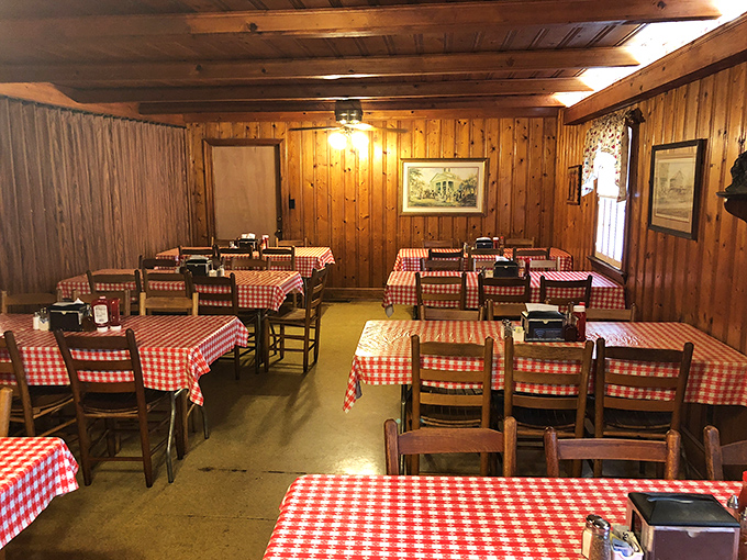 Red and white checkerboard tablecloths against pine paneling&mdash;the universal signal that serious, unpretentious eating is about to happen.