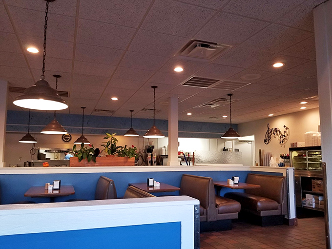 Blue accents and pendant lighting create that perfect diner atmosphere where conversations flow as freely as the coffee refills.