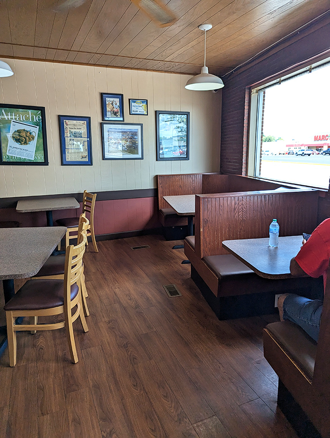 Wooden booths worn smooth by decades of satisfied diners, with walls proudly displaying press clippings. Every scratch tells a story of chicken-induced happiness.