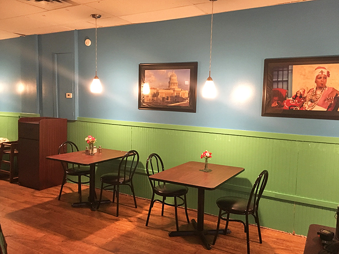 Simple wooden tables beneath bright blue walls create an atmosphere where conversations flow as easily as Cuban coffee after a satisfying meal.