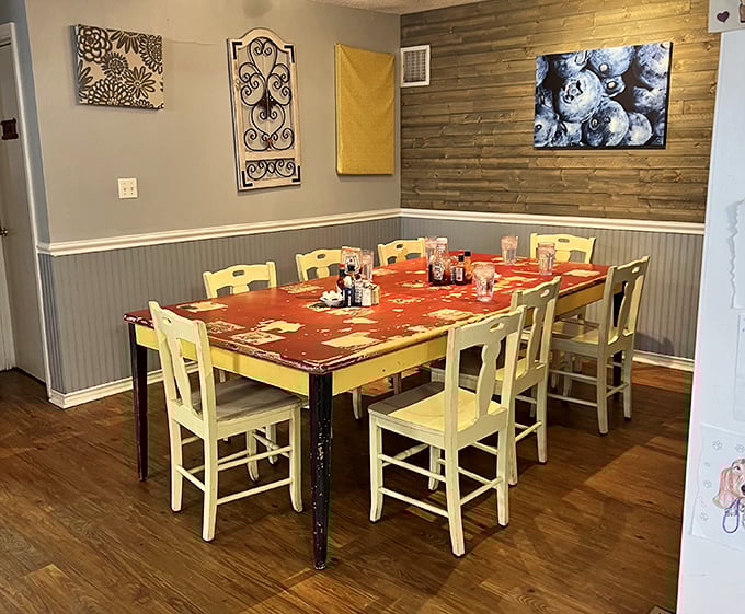 This charming dining nook with its rustic wood accent wall and yellow chairs feels like breakfast at your stylish friend's farmhouse – the one with actual taste.