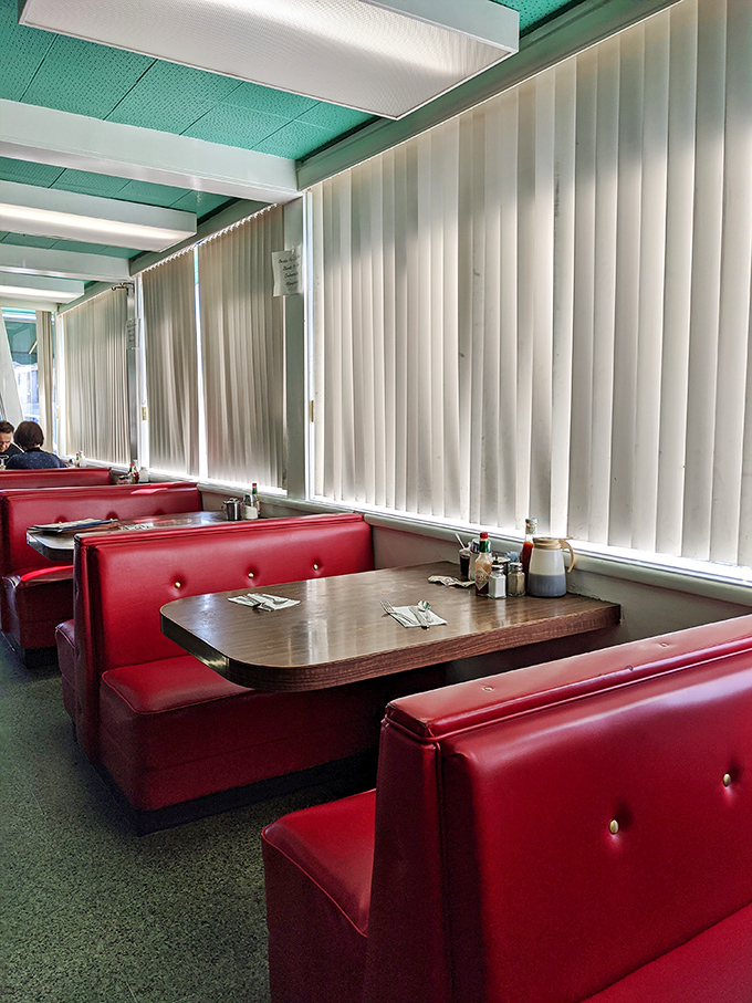 These red vinyl booths have witnessed first dates, family reunions, and countless Sunday morning recoveries. If only they could talk.