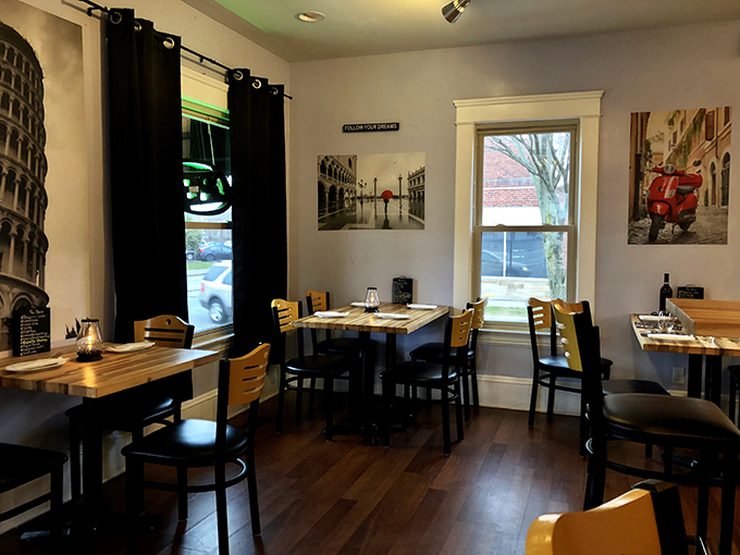 Italian scenes on the walls and wooden tables create an atmosphere that whispers "stay awhile" rather than shouting "authentic Italian!"