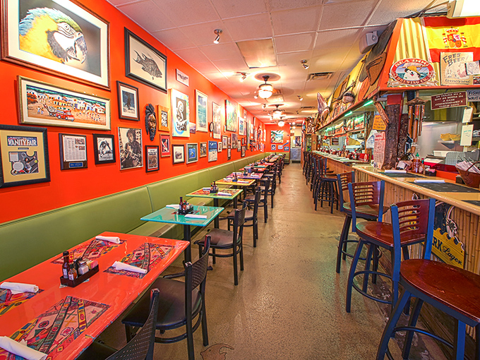 Vibrant coral walls lined with local art create a dining room that feels like the inside of Jimmy Buffett's imagination.