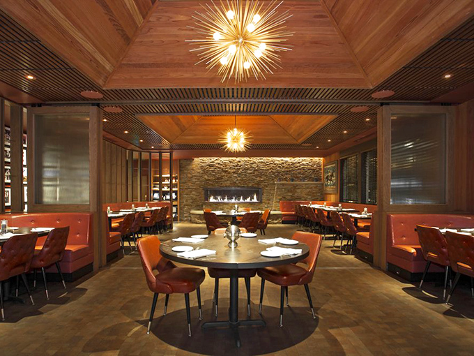 The dining room balances mid-century elegance with California warmth&mdash;those starburst chandeliers could have lit Frank Sinatra's dinner parties.