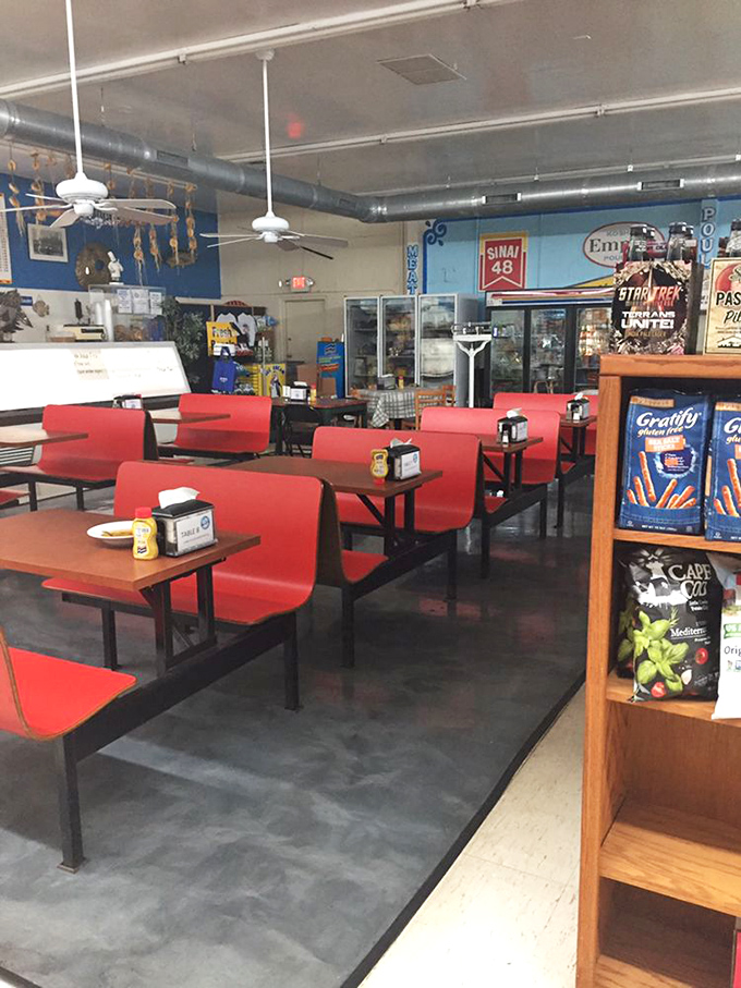 Red booths and friendly faces create the perfect setting for serious sandwich contemplation and lively conversation.