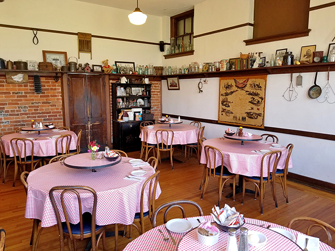 Pink checkered tablecloths and antique treasures create a dining room where every meal feels like Sunday dinner at your favorite relative's house.
