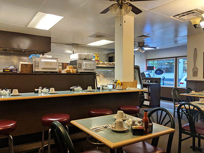 The counter and dining area – where strangers become neighbors and everyone's united by the universal language of breakfast.