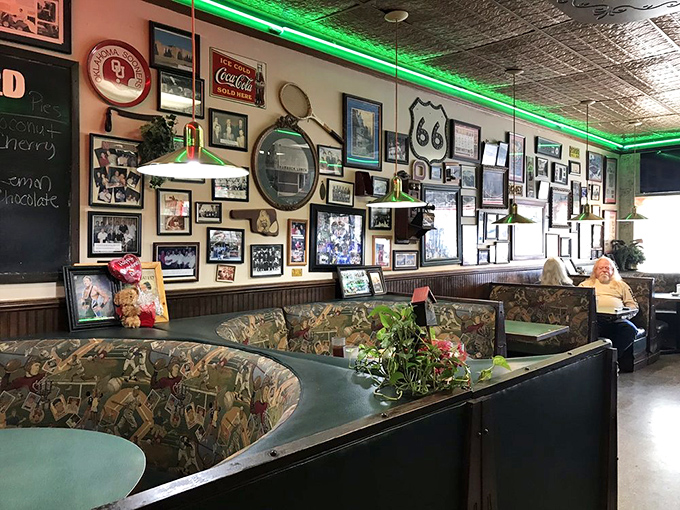 The wall of memories tells as many stories as the booths have heard. That Route 66 sign reminds you you're somewhere that matters.