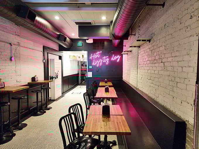 The dining area's industrial-chic vibe with exposed ductwork and brick walls creates the perfect backdrop for serious hot dog appreciation.