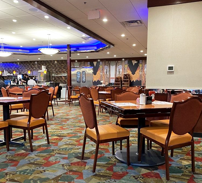 Empty tables waiting for their next story&mdash;where first dates, family celebrations, and Sunday morning recoveries all unfold under the same blue glow.