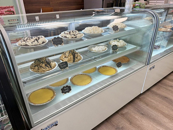 The display case: where dreams are stored at precisely the right temperature. Each pie waits patiently for its moment of glory.