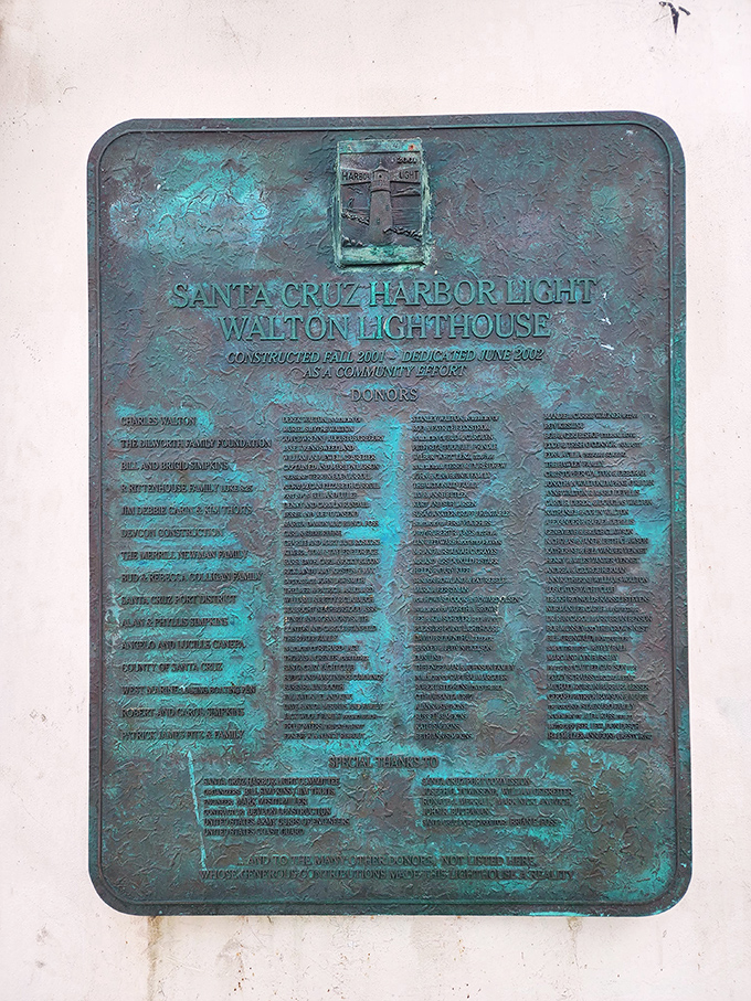 A weathered plaque tells the story of community spirit, with donors who understood that some beacons need more than government funding to shine.
