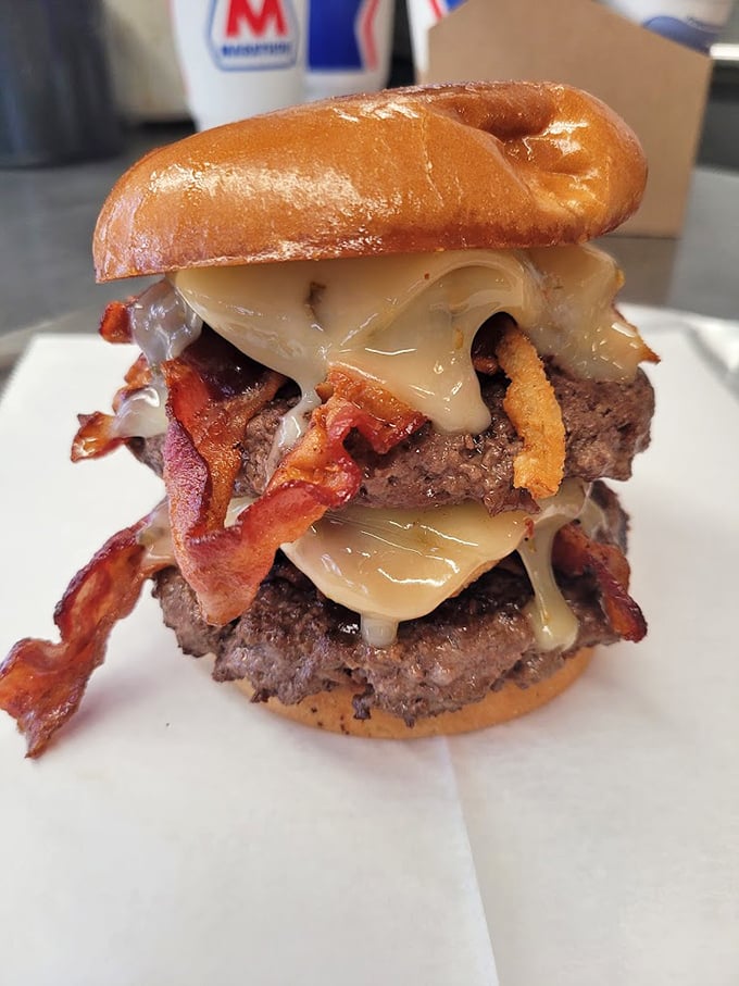 This double-decker burger with bacon and melted cheese isn't just a meal; it's a commitment worth making.