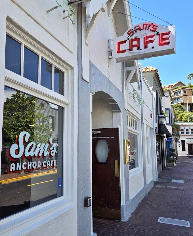 The white facade with that iconic red sign feels like the entrance to a secret club where seafood lovers gather.