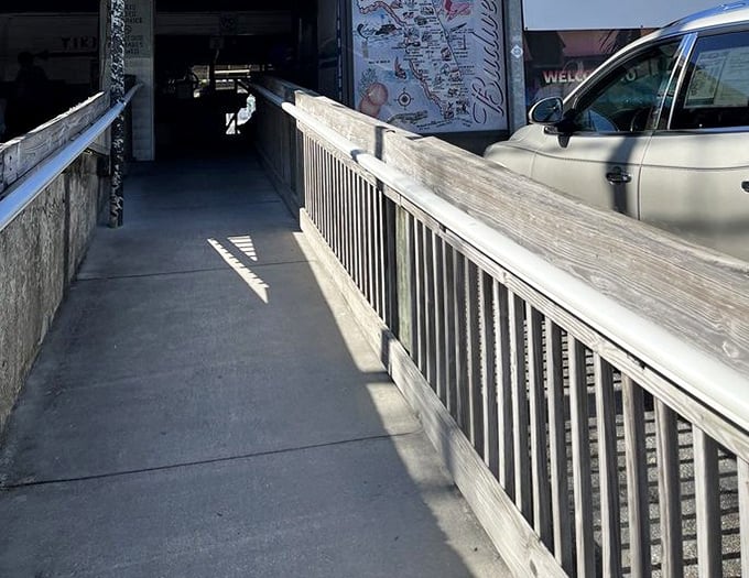 The entrance walkway feels like crossing a threshold between ordinary life and a hidden coastal treasure.