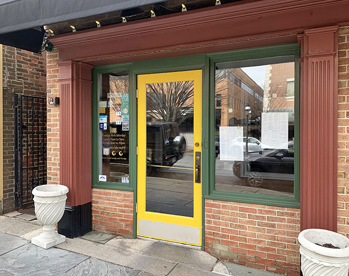 The welcoming yellow door beckons diners into what locals consider their neighborhood's best-kept culinary secret.