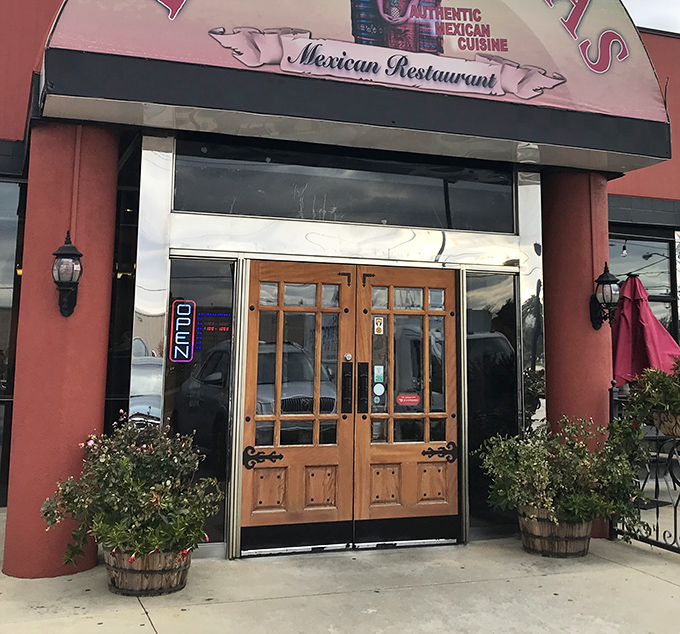 The welcoming entrance features rustic wooden doors that hint at the authentic experience waiting inside.