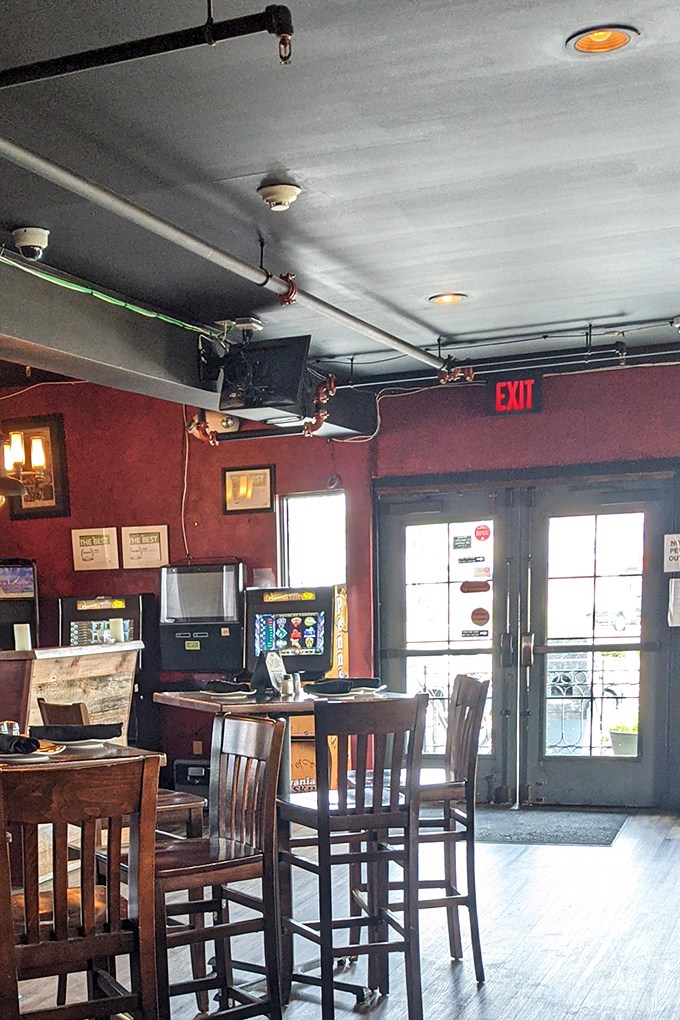 Red walls and wooden chairs create that "everybody knows your name" vibe—the kind of place where food and conversation flow with equal ease.