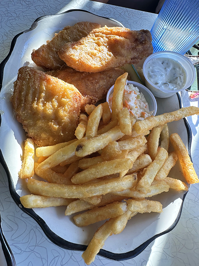 Fish and chips that would make the British jealous. That golden batter shatters with each bite, revealing flaky white fish beneath.