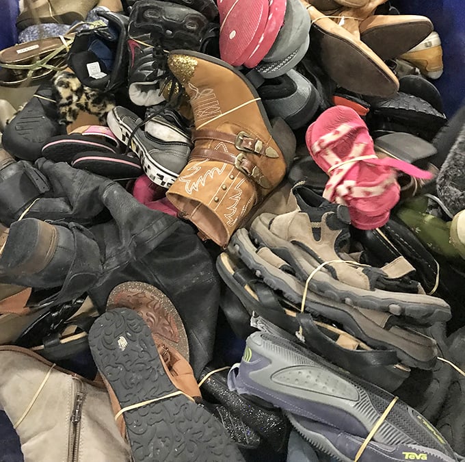 A footwear free-for-all where lone cowboy boots and forgotten sneakers await their perfect match. Somewhere in this pile is someone's next favorite pair.