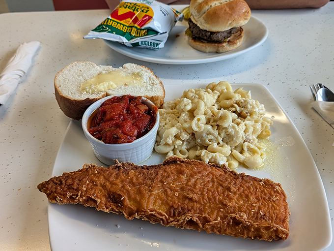Fried haddock so perfectly golden it deserves its own trophy, accompanied by mac and cheese that whispers "comfort" with every bite.