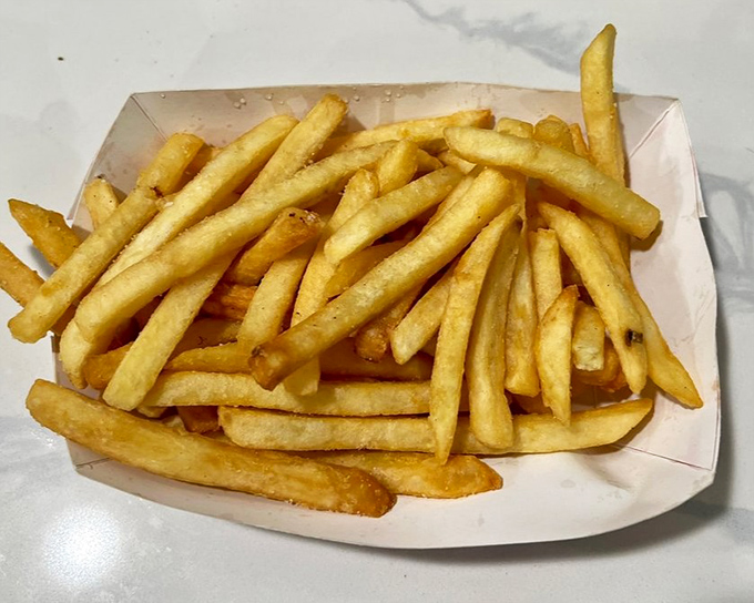 Golden fries that achieve that perfect balance—crispy exterior giving way to fluffy potato interior, no ketchup required but certainly welcomed.
