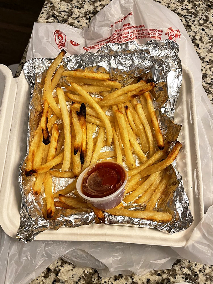 Hand-cut fries served unpretentiously on foil&mdash;because when they're this perfectly crisp outside and fluffy inside, fancy presentation is unnecessary.