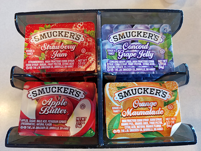 The jam caddy&mdash;where Smucker's varieties wait patiently to transform ordinary toast into the highlight of your breakfast battlefield tour.