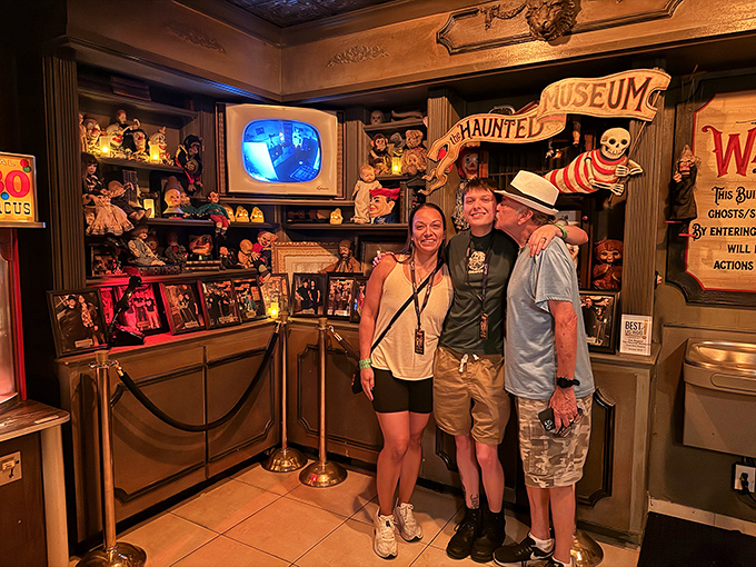 Visitors pose for a souvenir photo, their smiles saying "fun museum" while their eyes scream "please let me make it to the exit."