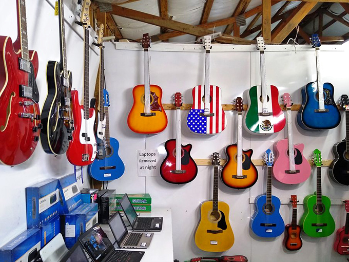A rainbow of guitars awaits new homes—from the stars-and-stripes patriotic to the beginner's first acoustic, each instrument carries music yet to be played.