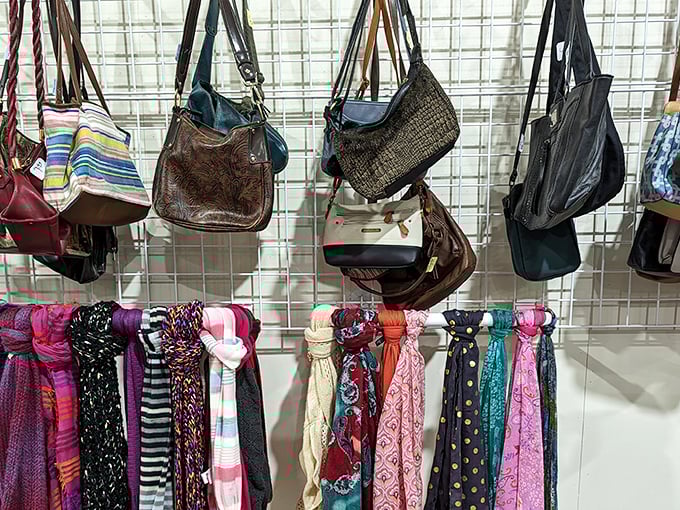 Handbags and scarves displayed like exotic butterflies. Each accessory whispers tales of previous adventures while awaiting its next chapter.