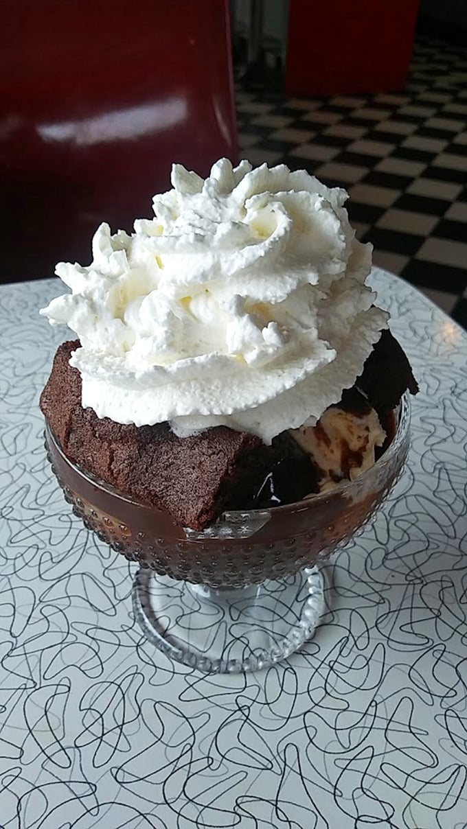 Hot fudge cake with a cloud of whipped cream&mdash;proof that sometimes the simplest desserts deliver the most profound happiness.