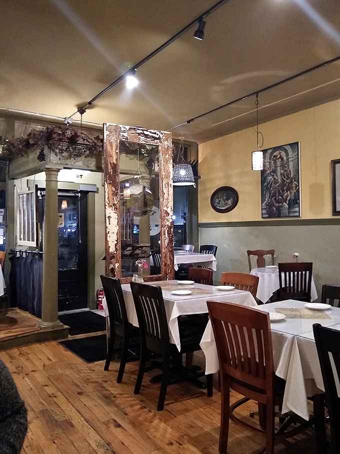 Rustic charm meets casual elegance in a dining room where weathered wood and white tablecloths create the perfect backdrop for memorable meals.