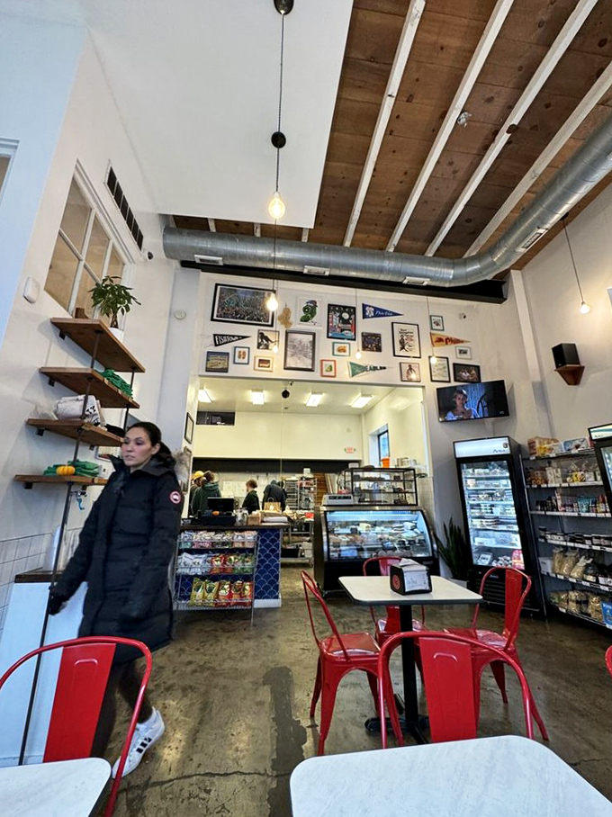 Exposed wooden beams, pendant lights, and walls adorned with local memorabilia create the perfect backdrop for serious sandwich consumption.