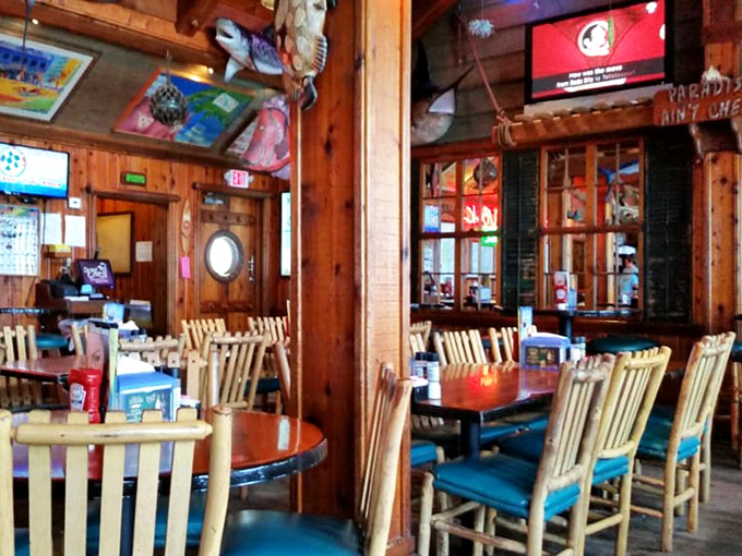 Wooden chairs await seafood enthusiasts like front-row seats at the ocean's tastiest concert, with fish mounted overhead as the headliners.
