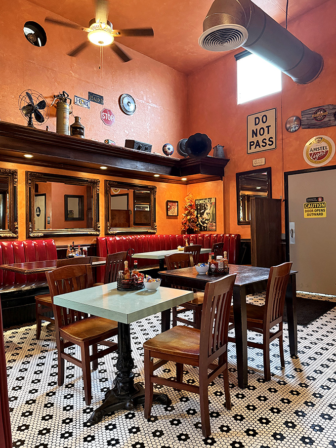 Vintage road signs and automotive memorabilia create a playful atmosphere that honors the building's gas station roots with nostalgic charm.