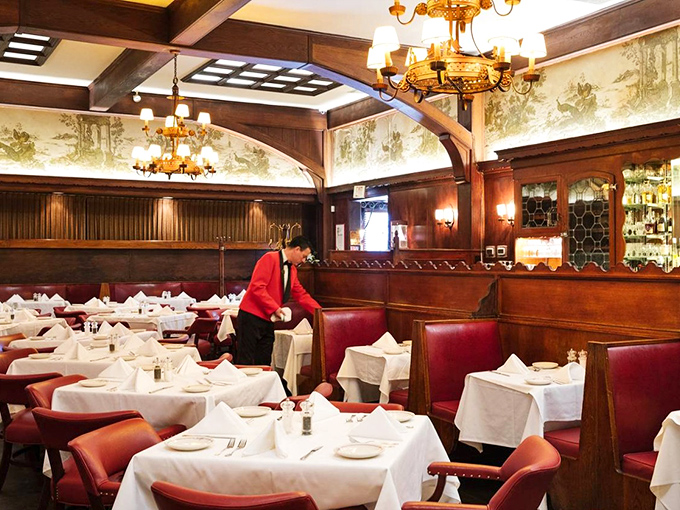 Red leather booths and white tablecloths set the scene for Hollywood magic. This dining room has hosted more stars than the Oscars.
