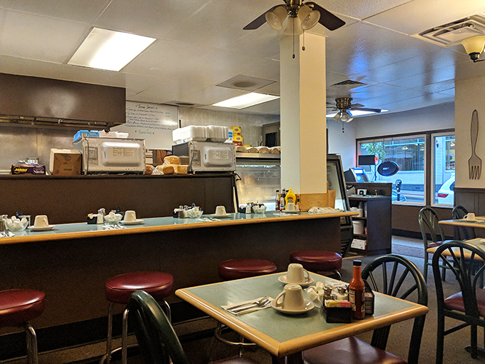 The counter seating and open kitchen layout &ndash; where breakfast theater happens daily and regulars have their unofficial assigned seats.
